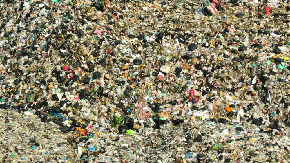 A dense mix of discarded items and debris, with notable patches of dirt ...