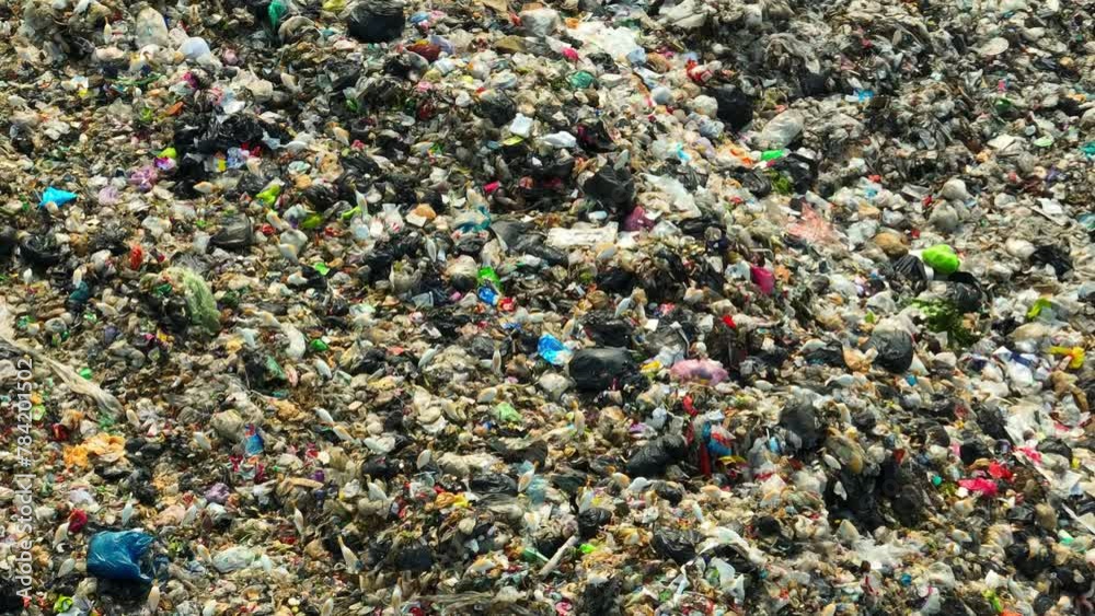 A detailed view of a landfill, showing a vast amount of mixed refuse ...
