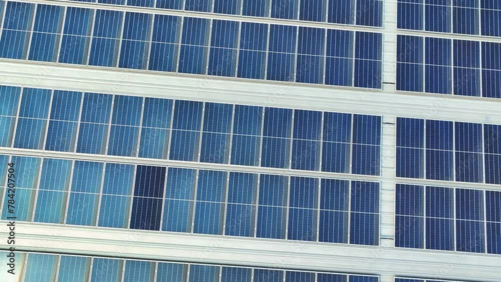 Vidéo Stock A sea of azure solar panels adorn the rooftop, capturing ...