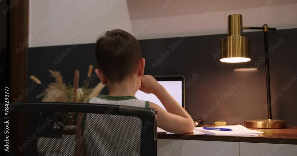 Back view child doing homework, cute kid a little boy studying at home ...