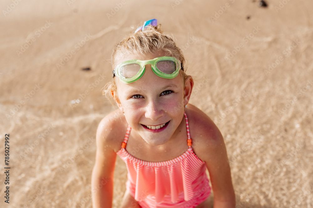 Young girl playing, swiming and splashing in fresh sea water. Smilling ...