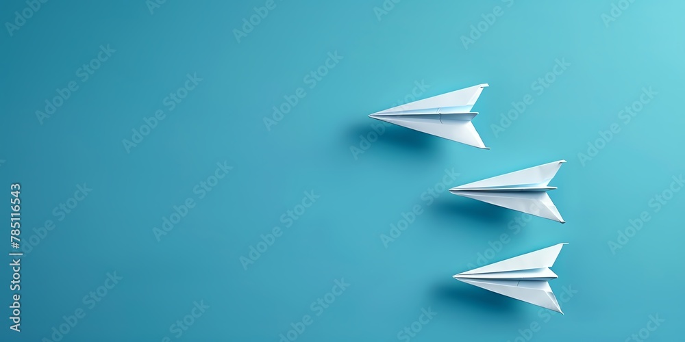 Three paper planes are flying in a blue sky. The planes are all white ...