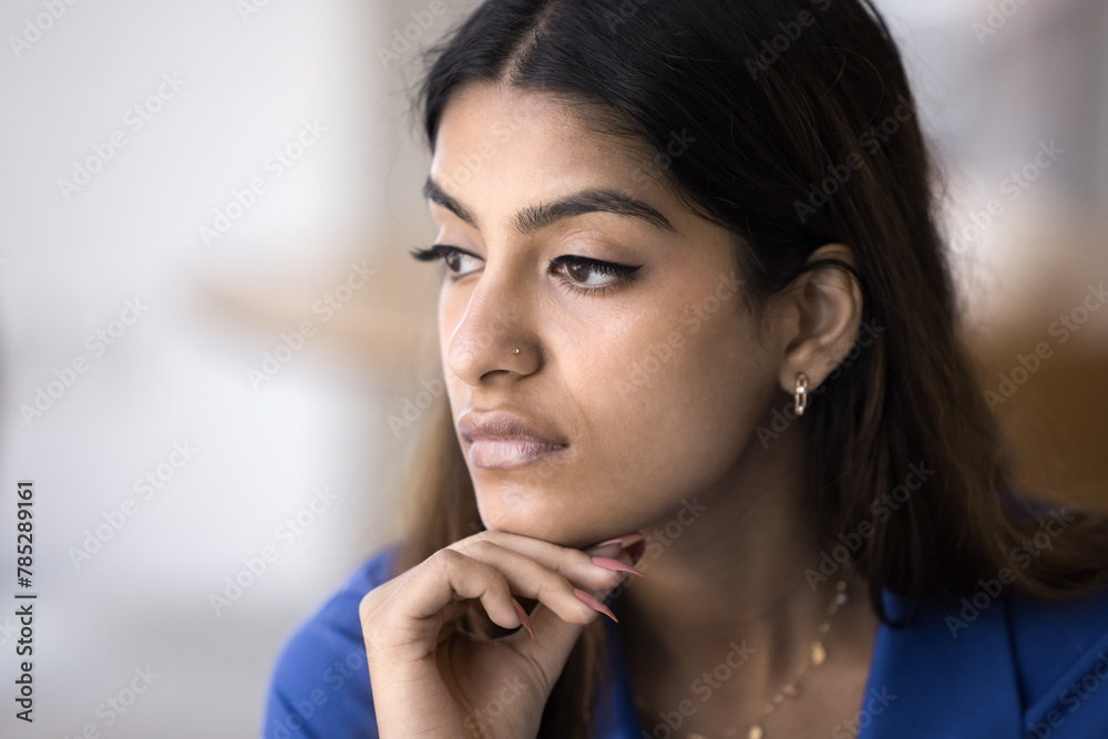 Sad pensive young Indian woman casual close up facial portrait ...