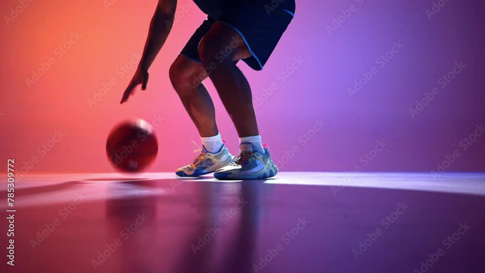 Basketball player demonstrates dribbling technique, moving step by step ...