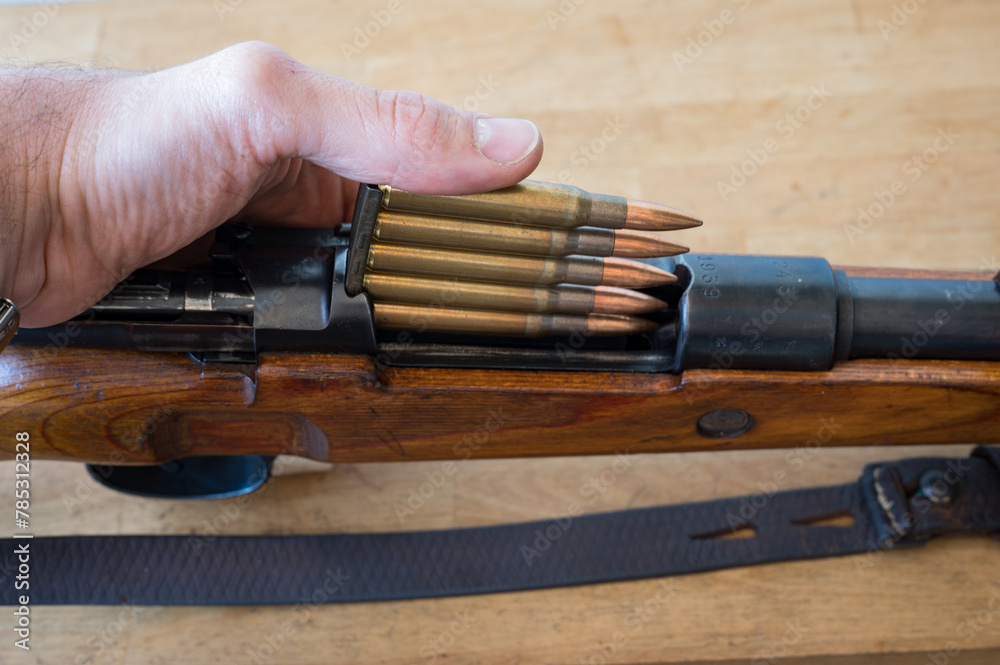 Detail of the insertion of an ammunition clip with 5 30-06 caliber ...