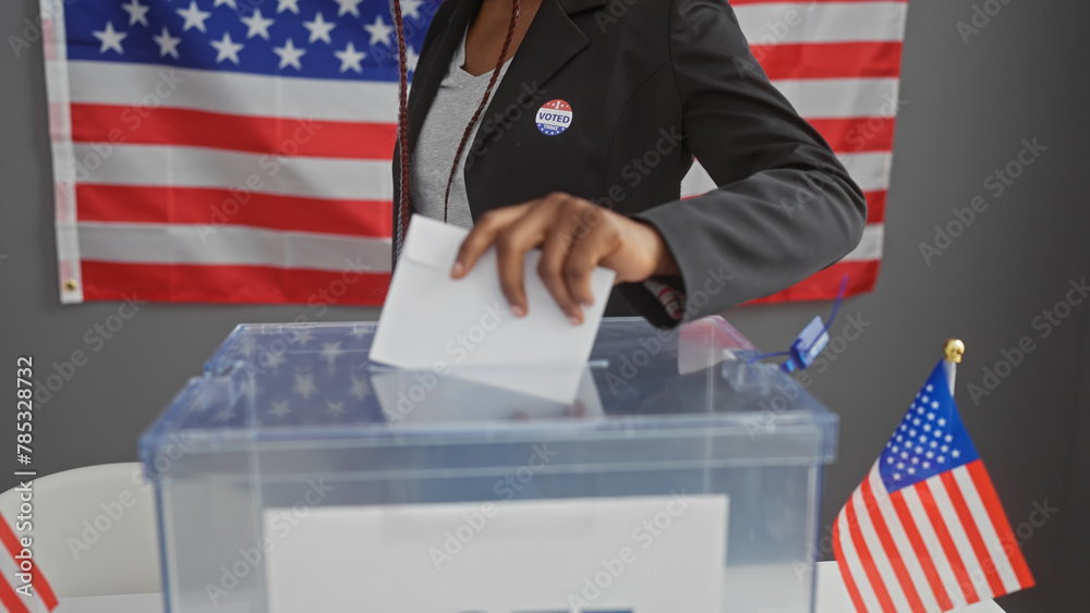 An african american woman with braids voting at an indoor electoral ...