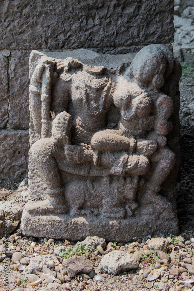 Lord Shiva and Parvati carved on a stone. Ruins of temple. Palasnath ...