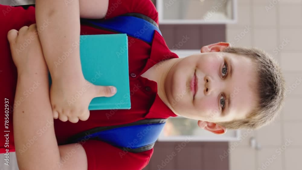 boy child kid schoolboy first grader backpack holding textbook book ...