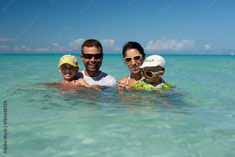 mom and dad with children, playing with kids, family on the beach ...