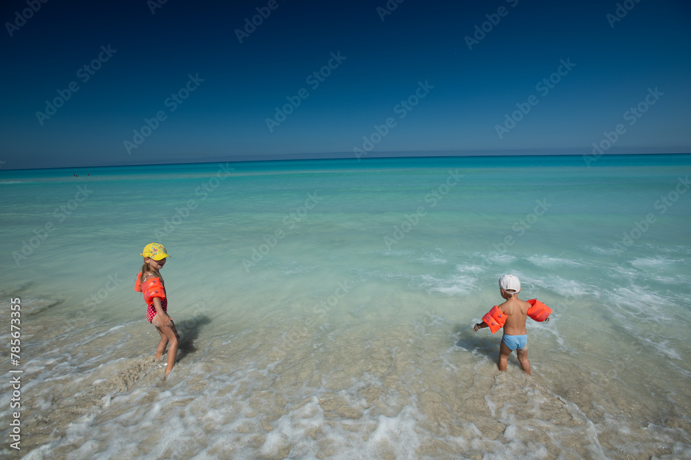 children swimming in shallow water, happy childhood, summer swimming ...