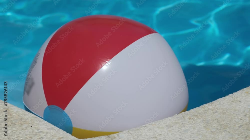 Vidéo Stock Colourful inflatable beach ball floating in shiny blue ...