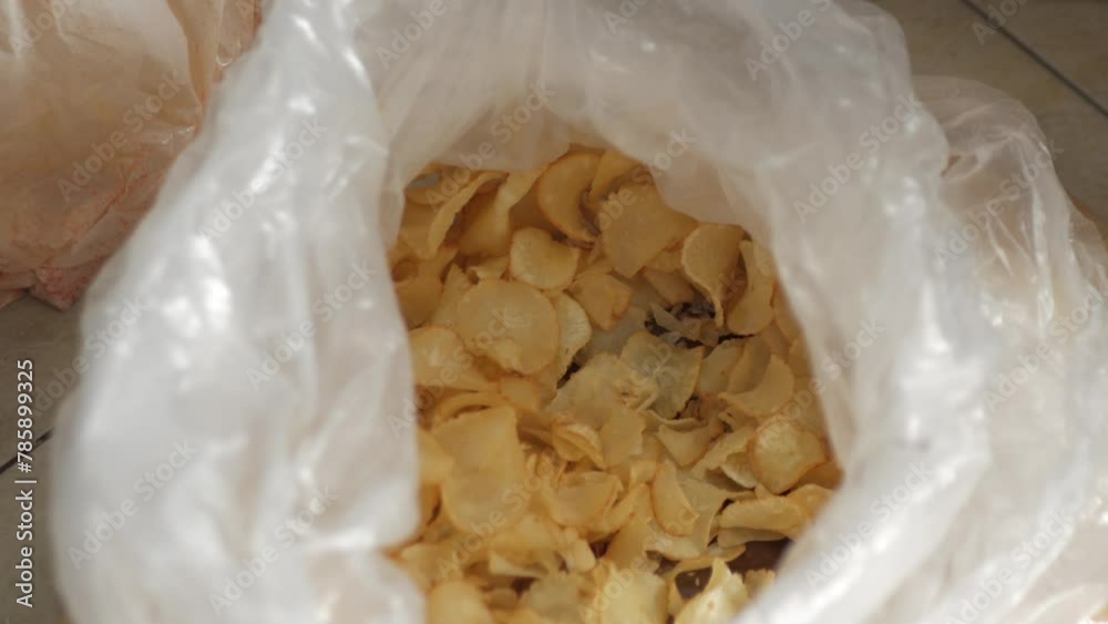 Cassava chips stored in plastic containers, taken for repackaging. Top ...