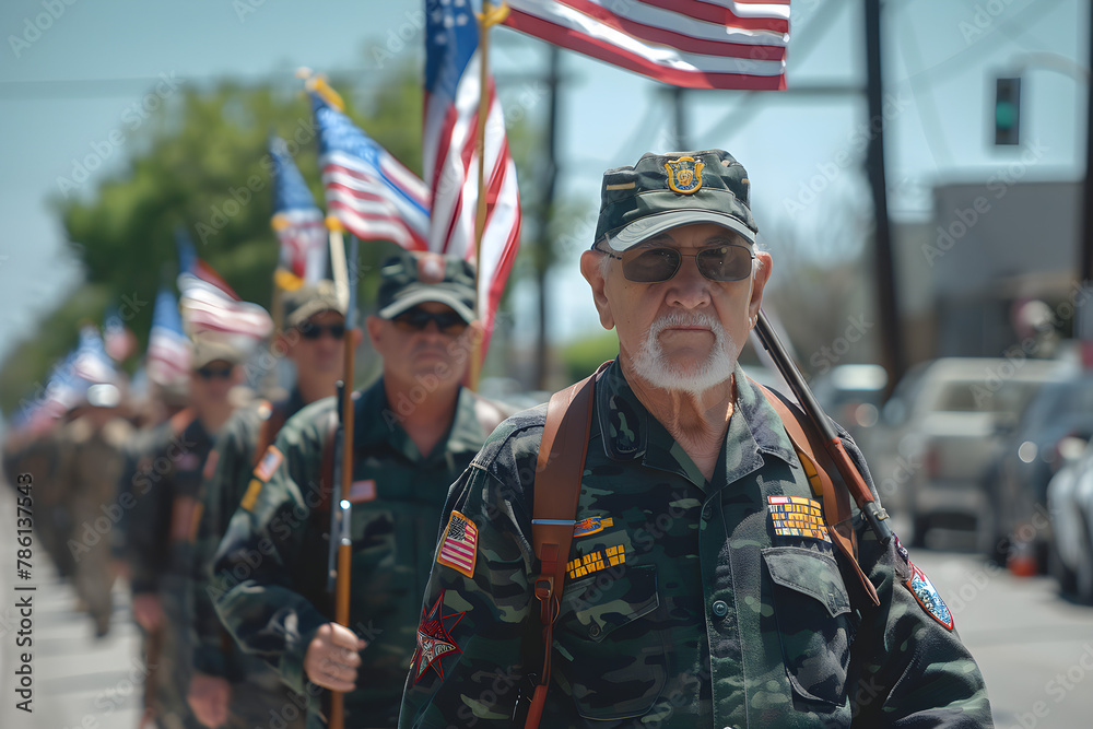 Veterans marching in a memorial day parade, carrying banners and flags ...
