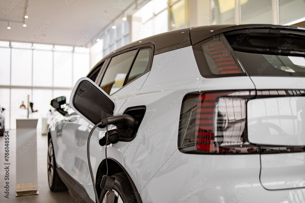 Exterior of new brand fully electric suv car in light dealership ...