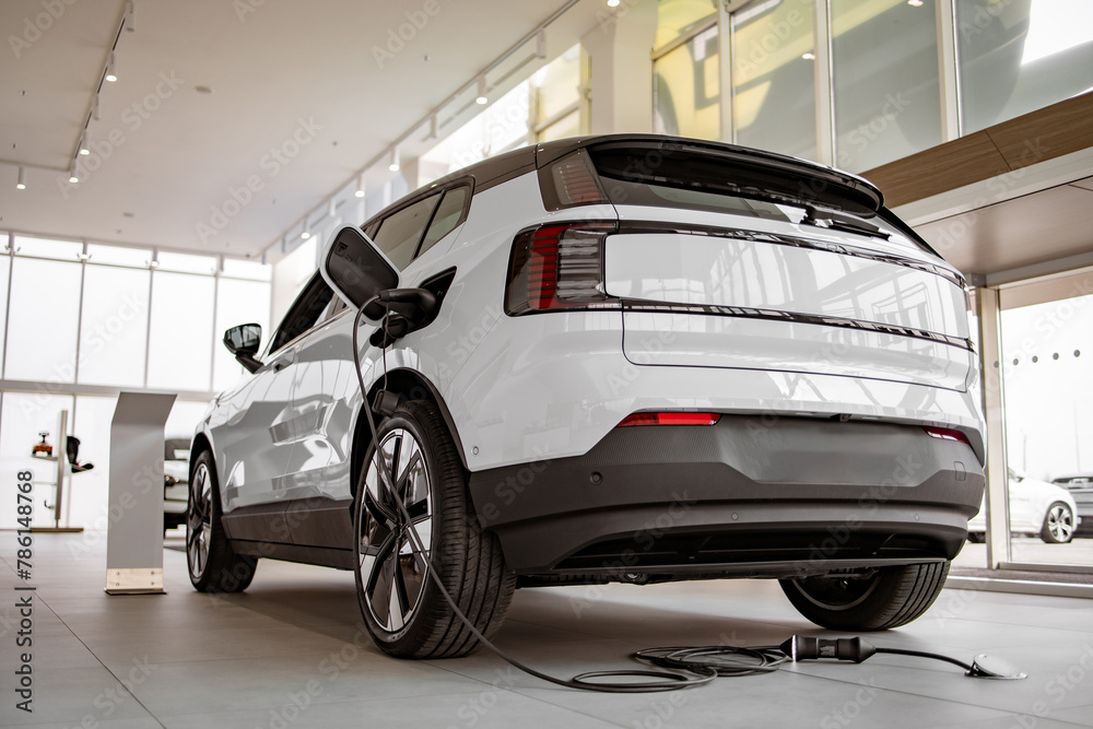 Exterior of new brand fully electric suv car in light dealership ...
