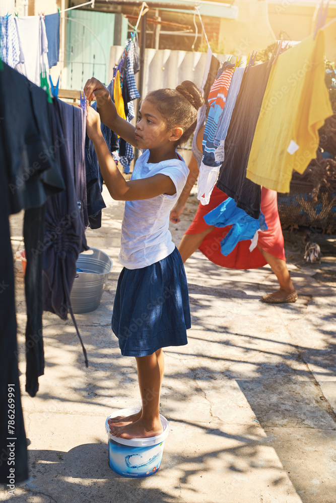 Child, hanging and laundry washing with outdoor sun for housekeeping ...