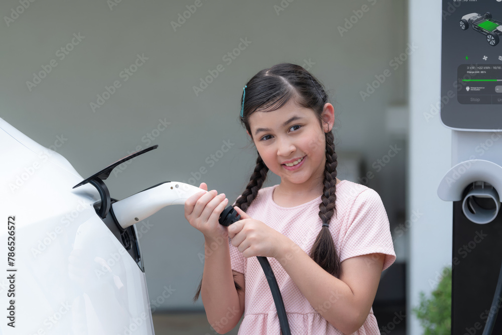 Happy little young girl learn about eco-friendly and energy ...