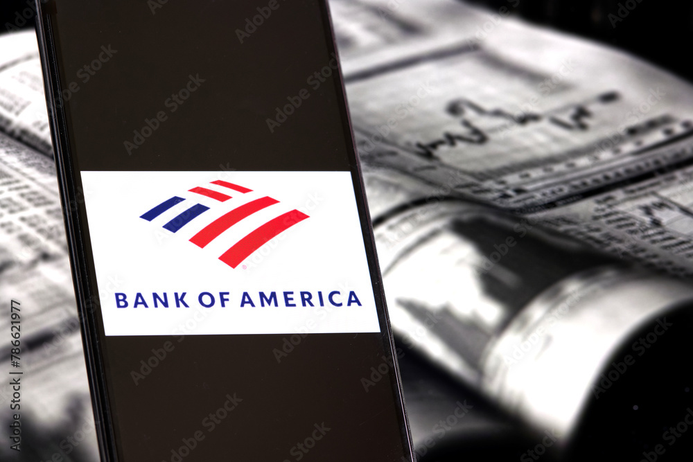 Bank of America, company logo is displayed on a smartphone, with the stock chart newspaper ...