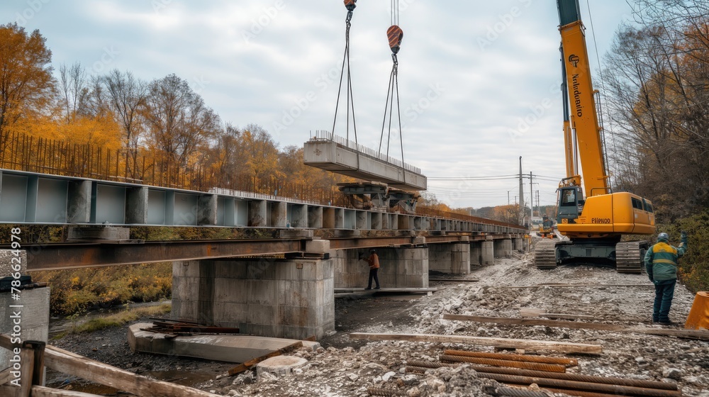 transporting large construction equipment as workers reinforce a bridge ...