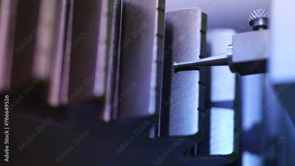 metal gear lead profile testing process. close up of stylus probe ...