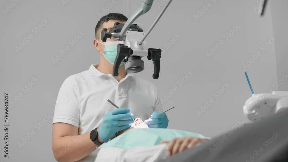 During the tooth extraction procedure, the doctor uses a microscope to ...
