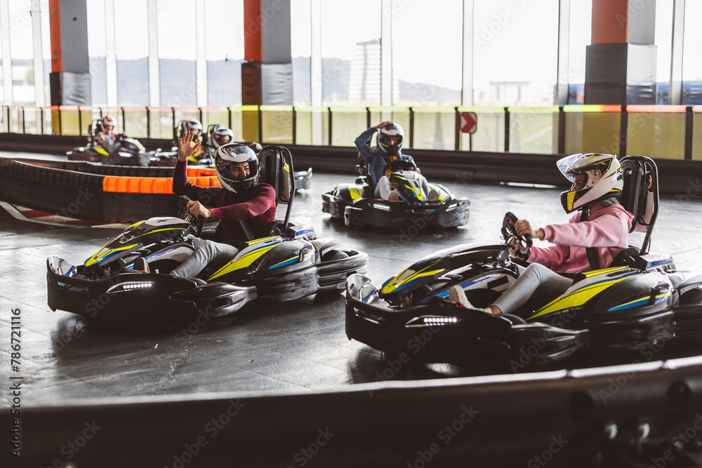 Kart racers take to the track to compete. A competitor hits a car in ...
