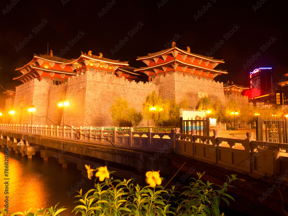 Macau night scenery with illuminated fortress with wooden pagoda roofs ...