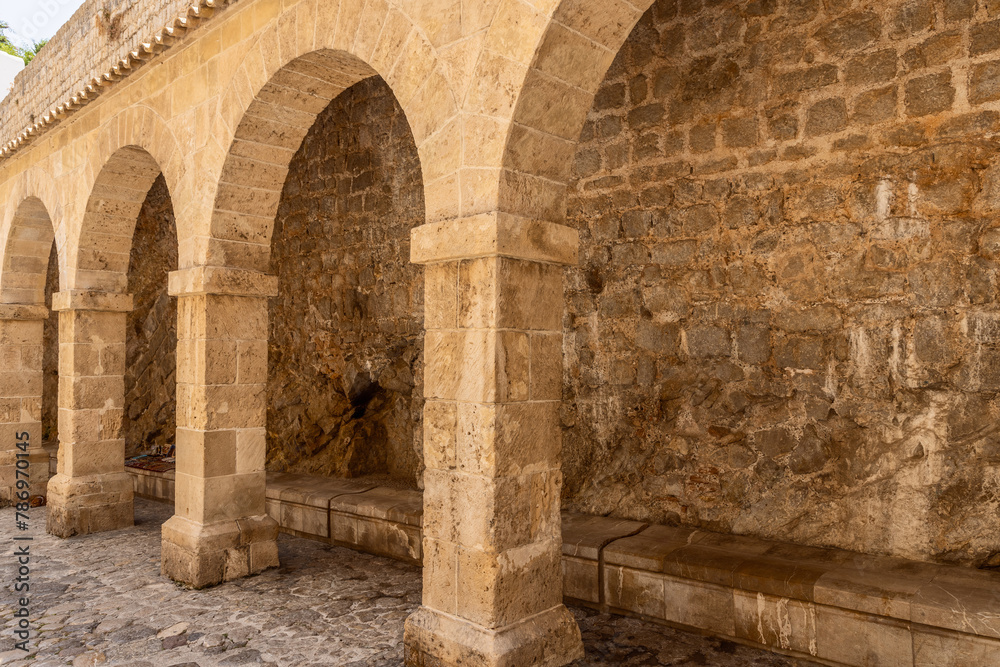The elegant portico with arches at the main entrance of Almudaina ...