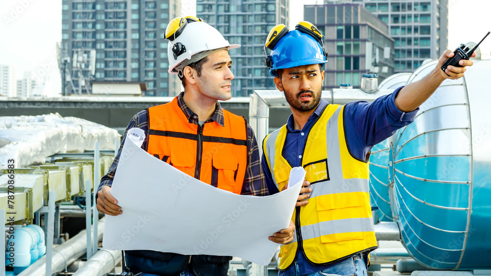Contractor, Two civil engineers checking information from blueprint ...