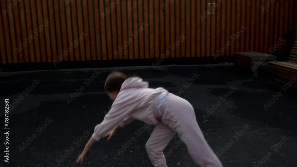 A teenage girl learns to walk on her hands and falls. Gymnast is ...