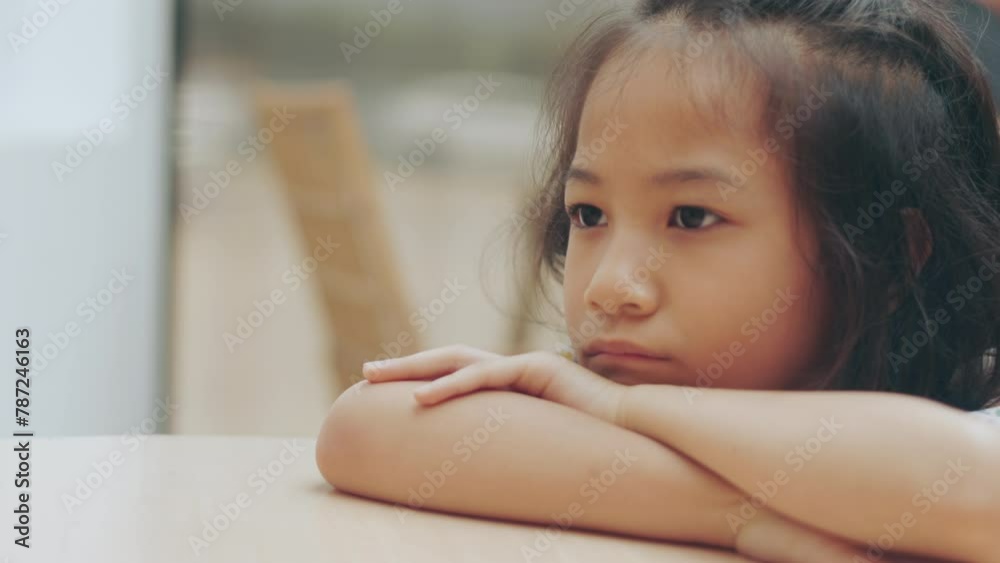 Face close up with copy space of adorable Asian kid girl who is laying ...