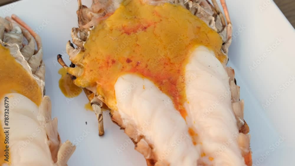 Large river prawns are grilled and cut in half to reveal the meat and ...