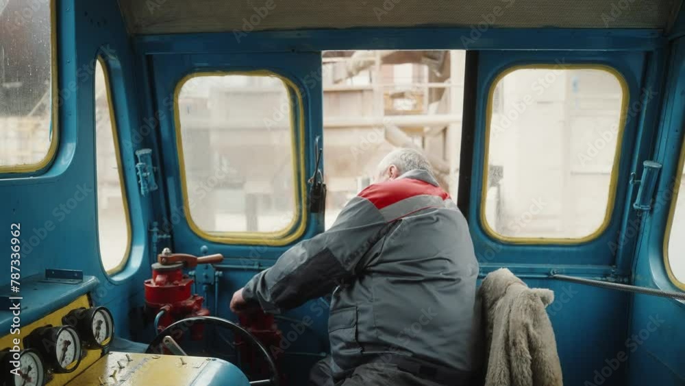 Man operating driving old steam locomotive, adjusting gas. Inside the ...