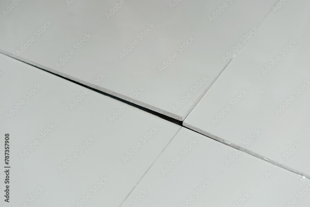 Ceramic tiles floor cracked and broken from concrete inflate in house or office building.House ...