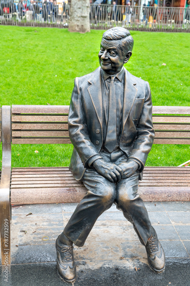 London, UK - March 22, 2024 : Statue of Mr Bean sitting on a bench ...