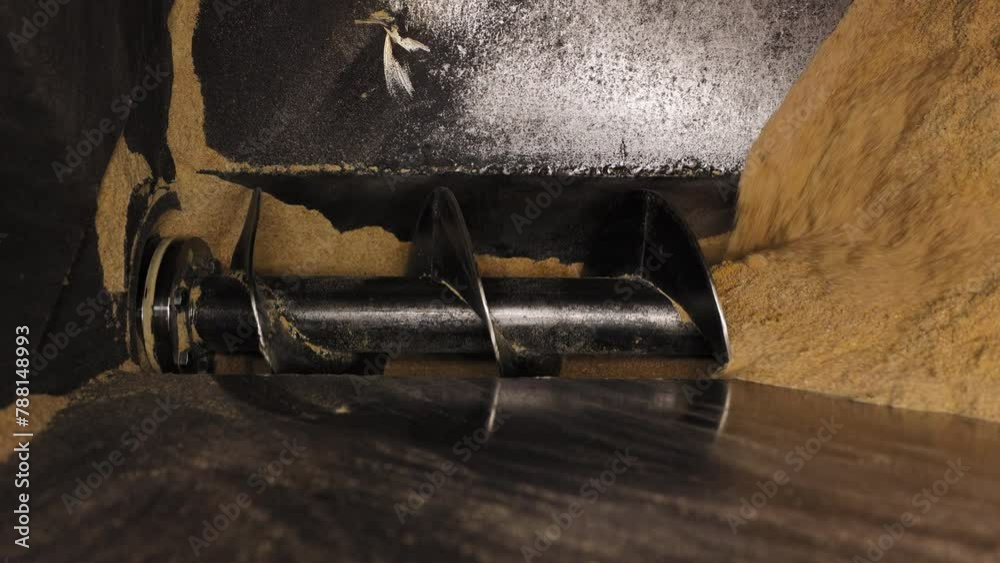 Massive black propeller with blades rotating and mixing crushed ...