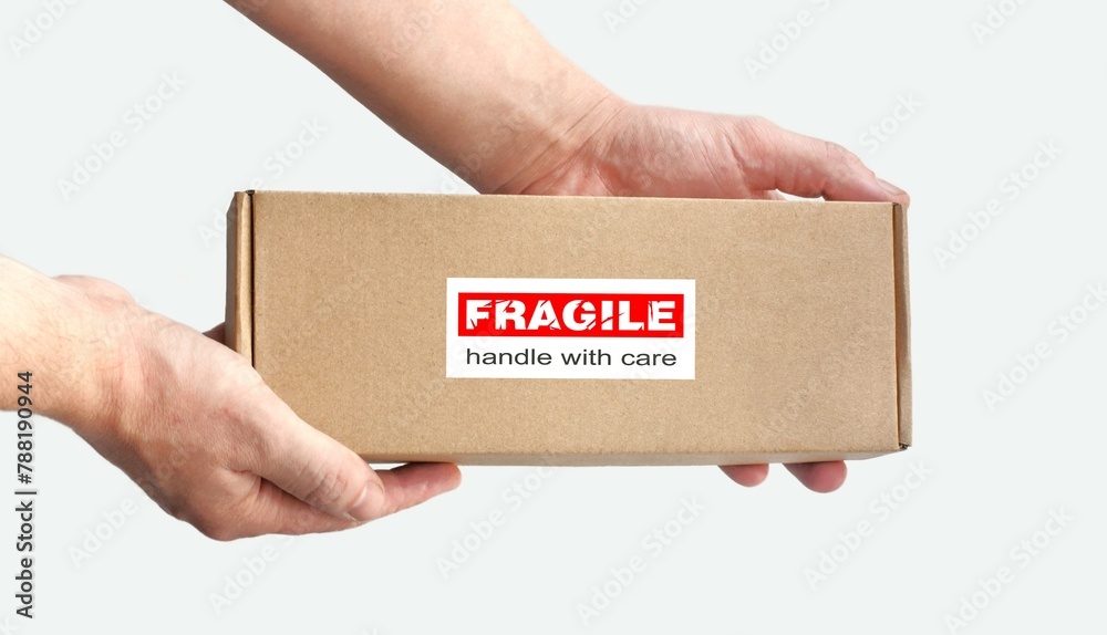 One rectangular cardboard box in hands for fragile items packing on a ...