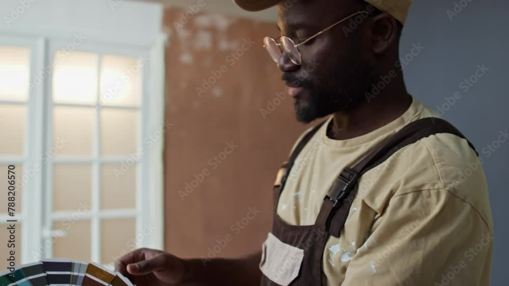Tilt footage of anonymous client and African American handyman choosing ...
