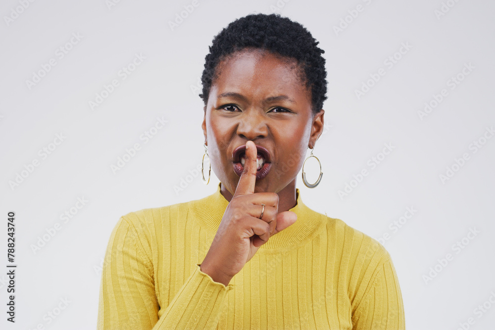 Portrait, secret and shush with angry black woman in studio isolated on ...