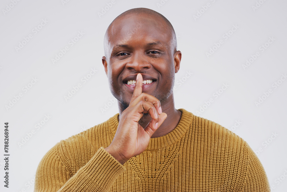 Portrait, smile and shush with private black man in studio isolated on ...