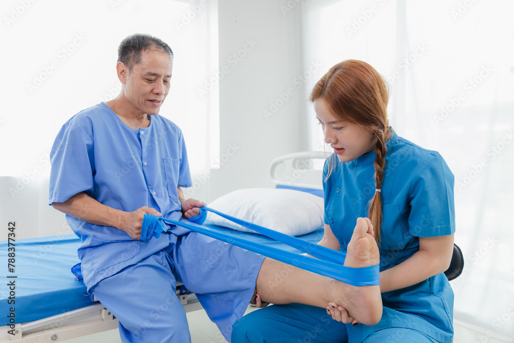 Asian female physiotherapist helping senior older woman stretching ...