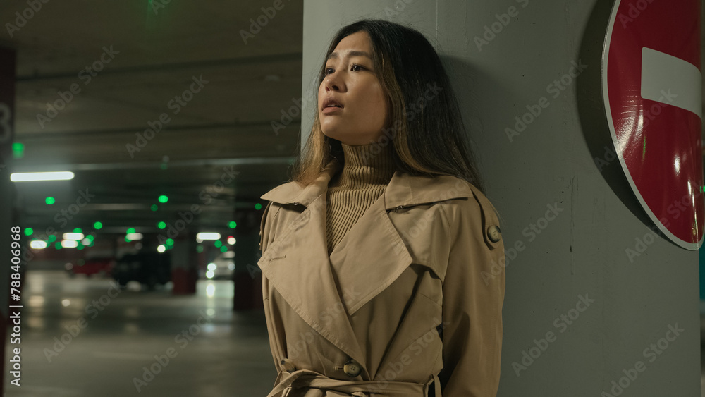 Frightened Asian ethnic chinese korean woman hiding from danger pursuit ...