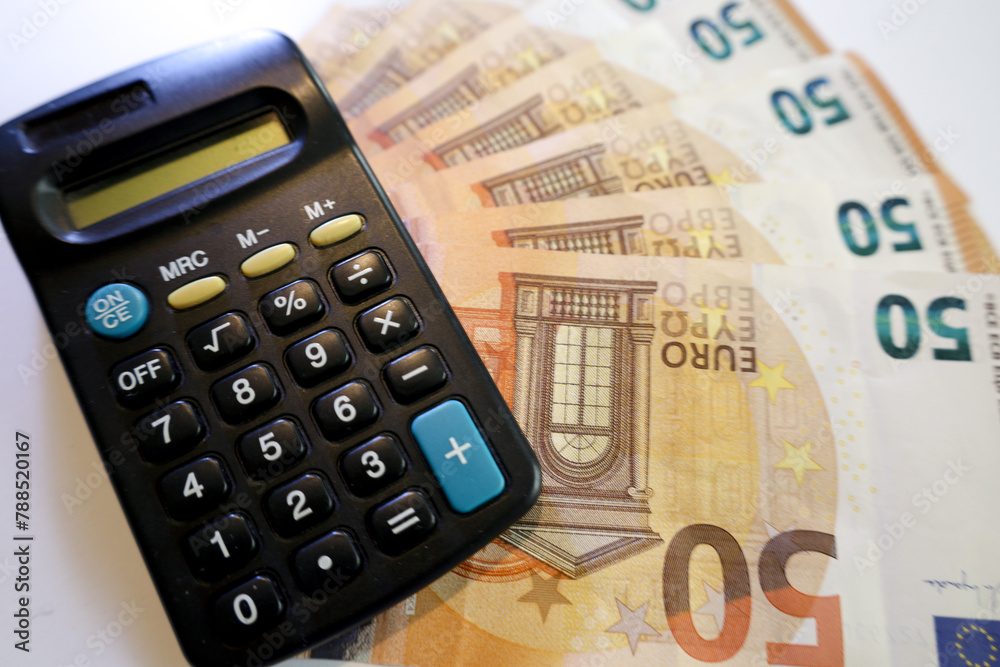 calculator and Euro banknotes on white background Stock Photo | Adobe Stock