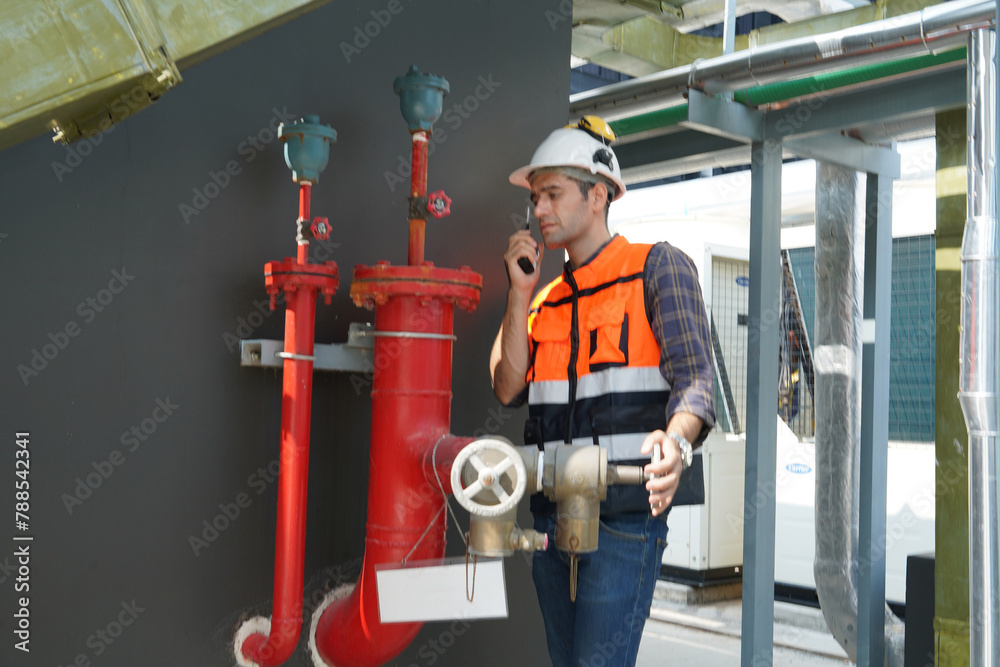 Foreman engineer wearing reflective jacket, engineering helmet, talking ...