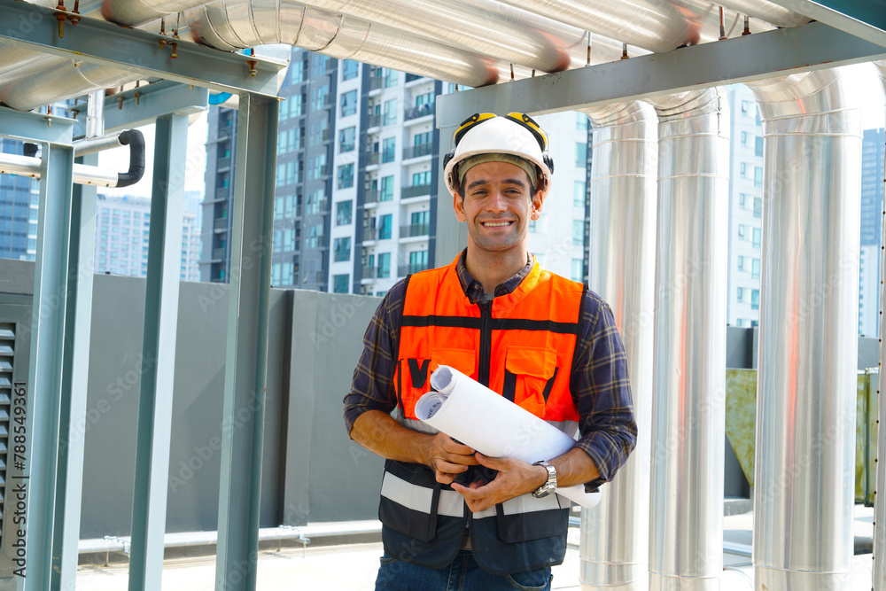 Asian male engineer wearing a reflective jacket, hard hat, standing ...