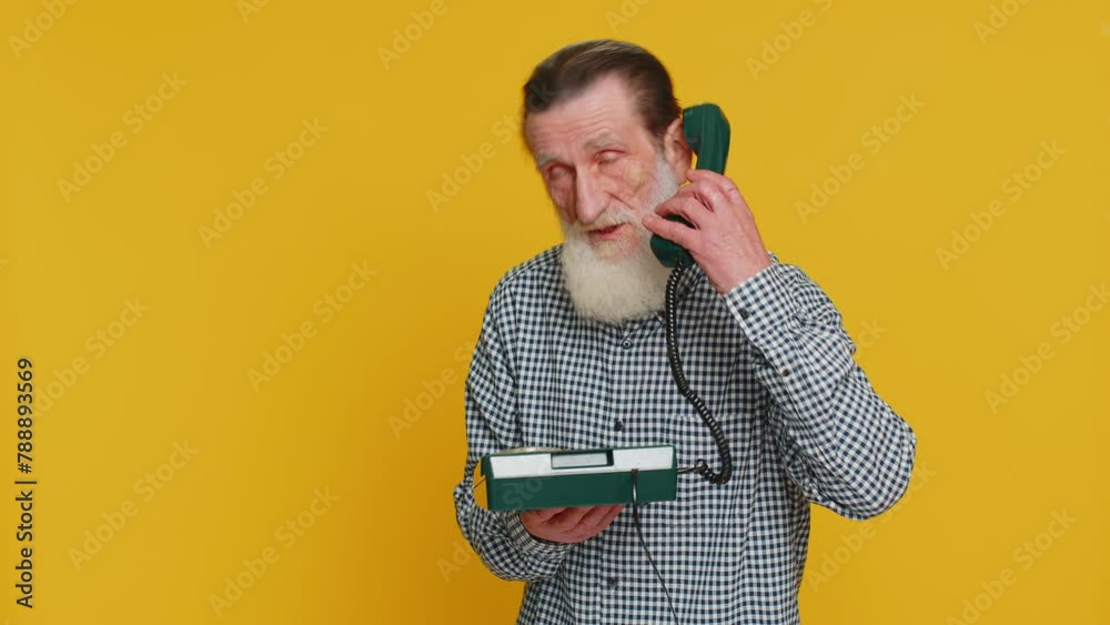 Hey you, call me back. Senior old man talking on wired landline vintage ...