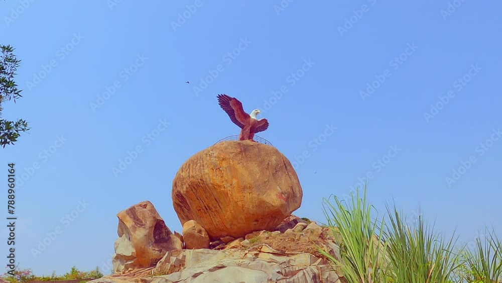 Sculpture of Jatayu (Eagle of Ramayana) with wings spread on huge rock ...