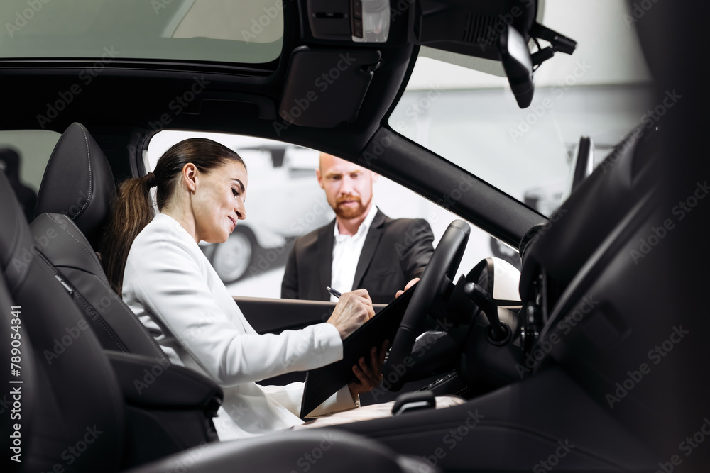 Close-up of the completion of a deal to purchase a new car at a car ...