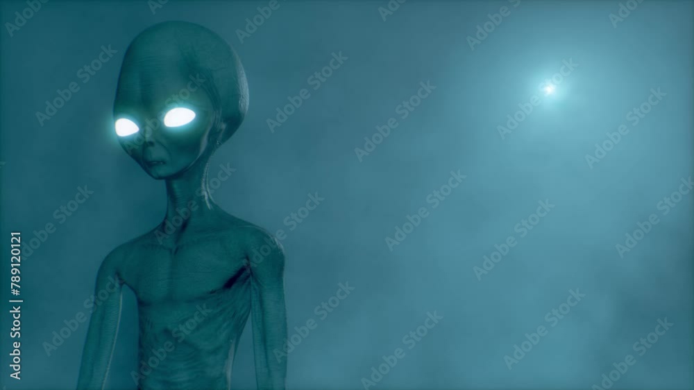 Scary gray alien standing and blinking at the dark foggy background of ...