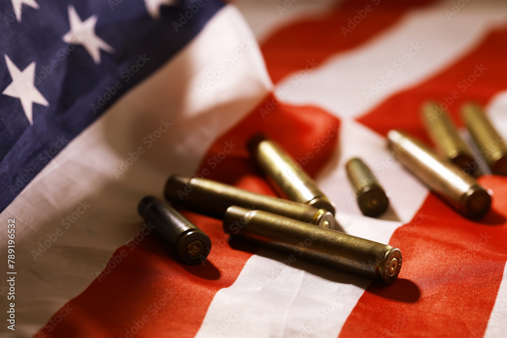 Many bullets cartridges and medals on United States flag. Concept of ...